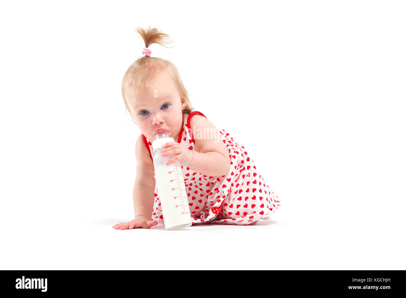 cute beauty baby girl in red dress hold milk bottle Stock Photo - Alamy