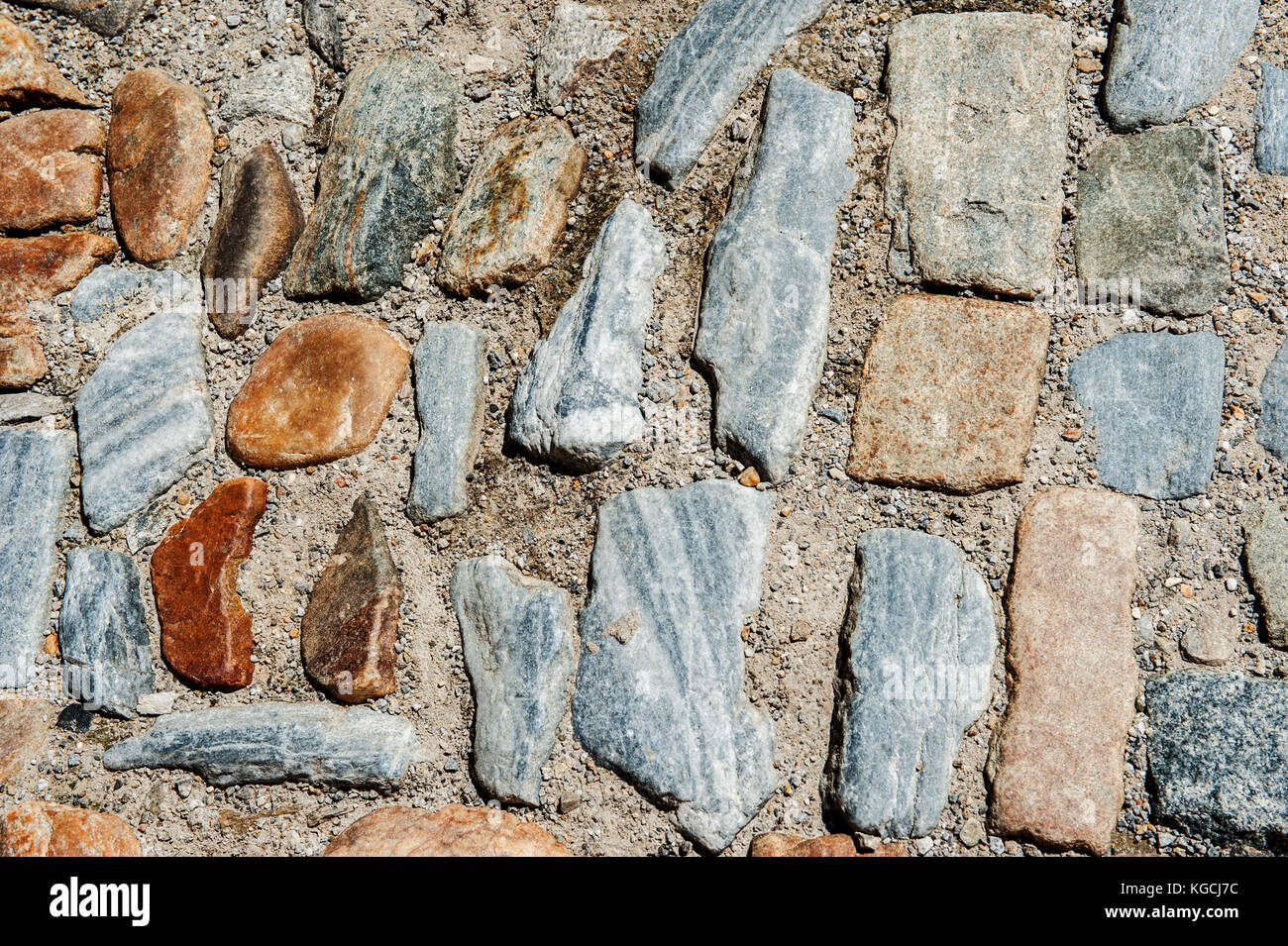 Beautiful multi-colored textured large stone cobbles in sand. The ...