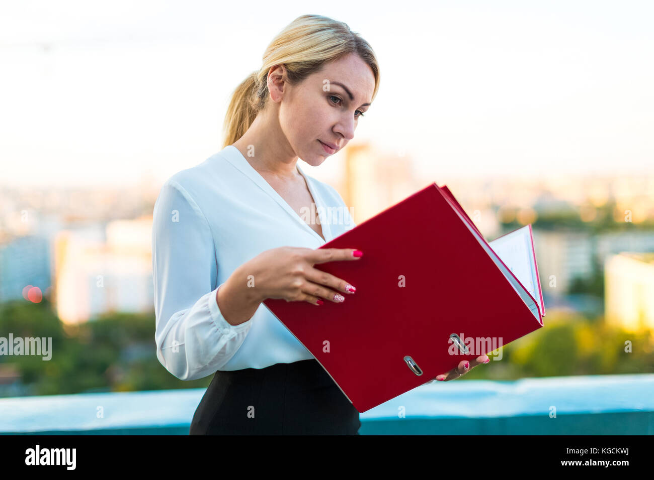 Young attractive business lady stand on the roof with paper fold Stock ...