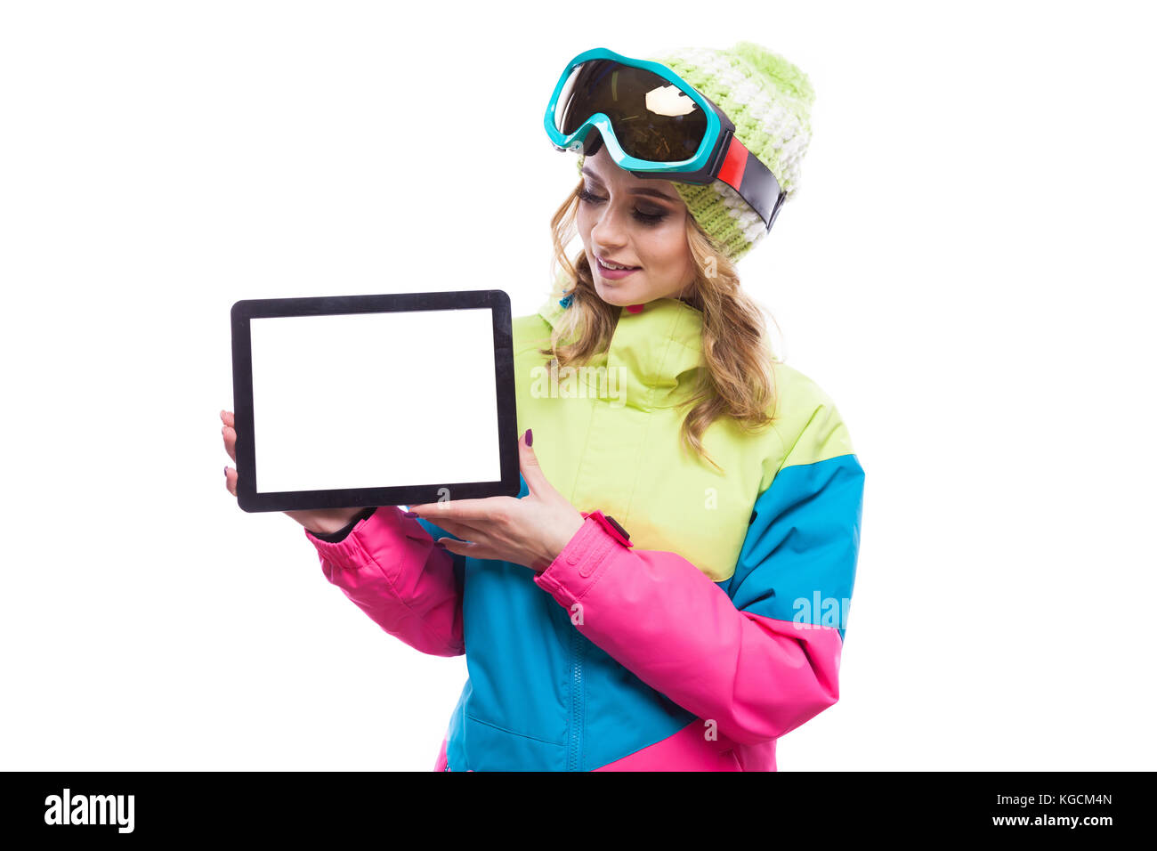young woman in ski suit hold empty tablet Stock Photo - Alamy
