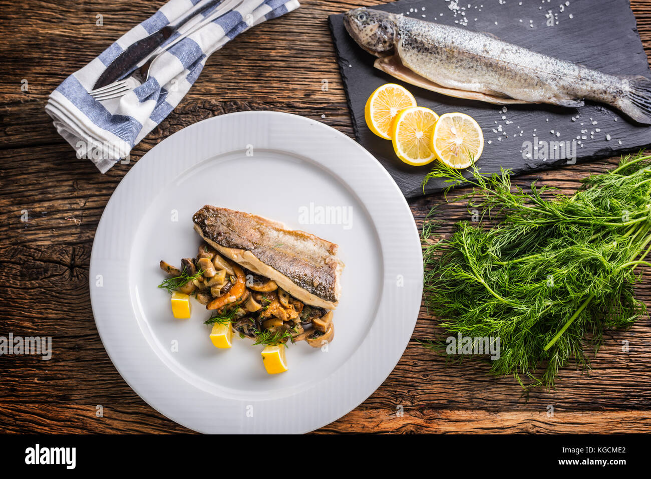 Fish trout with mushrooms and vegetable on plate in hotel or restaurant ...