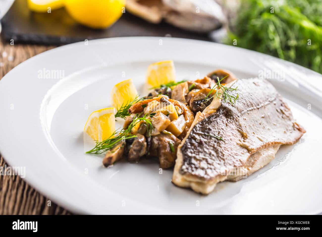 Fish trout with mushrooms and vegetable on plate in hotel or restaurant ...