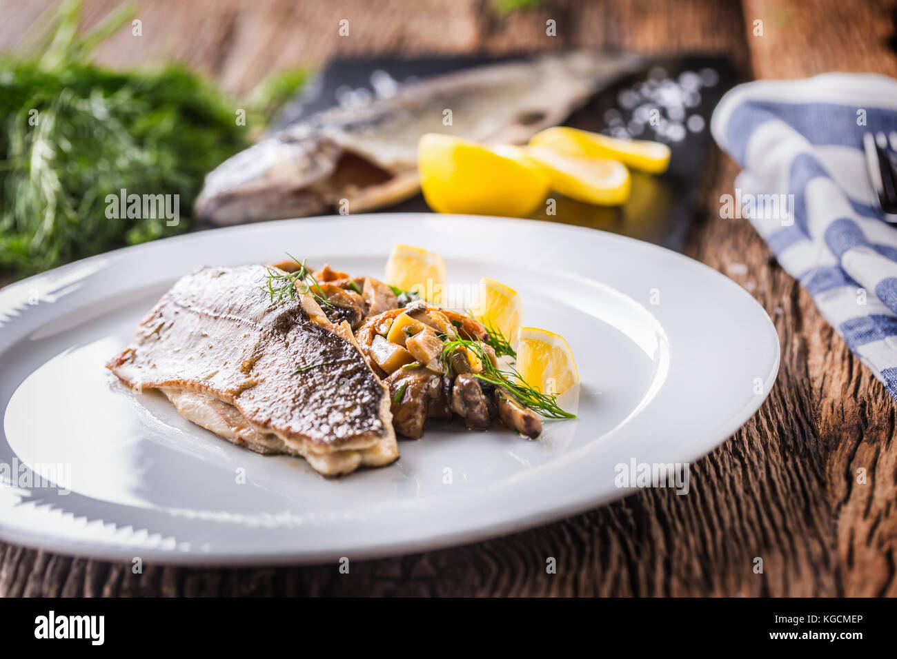 Fish trout with mushrooms and vegetable on plate in hotel or restaurant ...