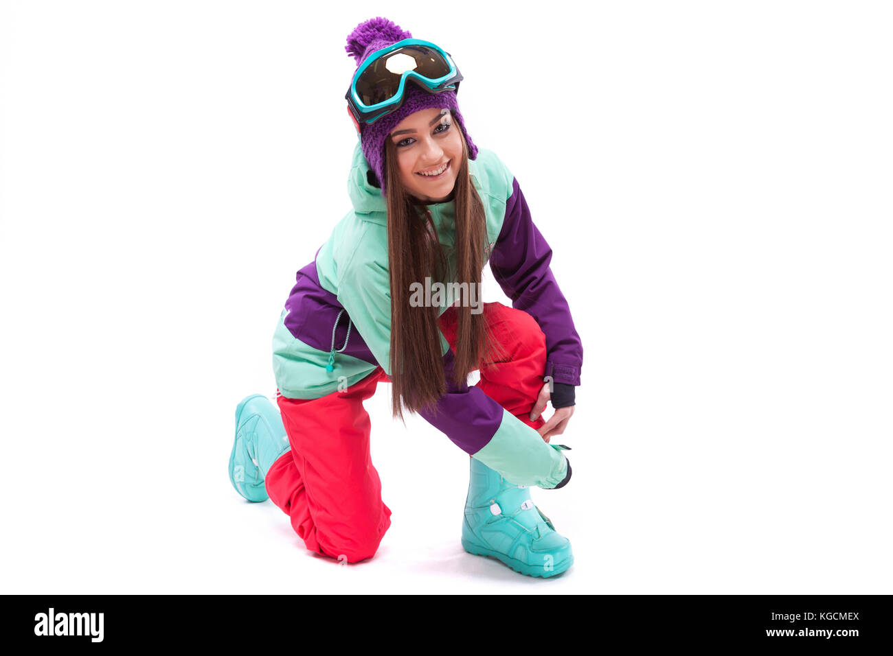 pretty ski girl standing on one knee Stock Photo - Alamy