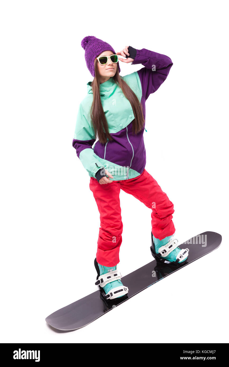 pretty young brunette woman in purple ski costume rides black snowboard ...