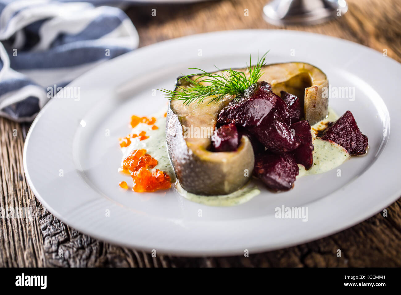 Sturgeon fillet with caviar beetroot and dill on plate in hotel or ...