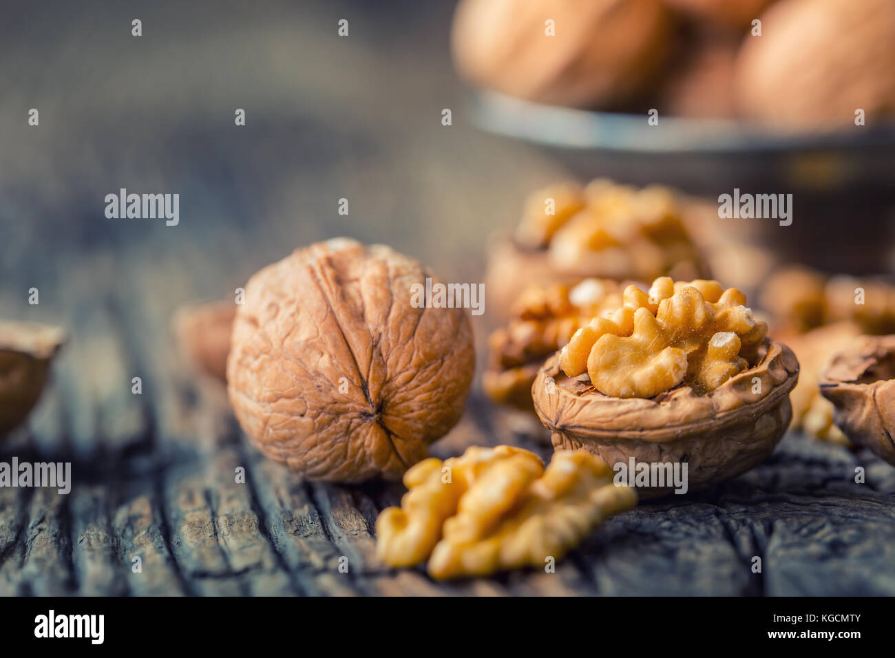 Walnut. Walnut kernels and whole walnuts on rustic old oak table Stock ...