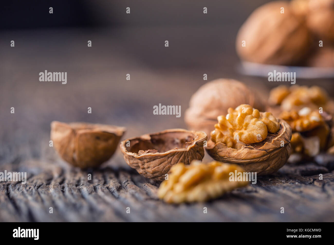 Walnut. Walnut kernels and whole walnuts on rustic old oak table Stock ...
