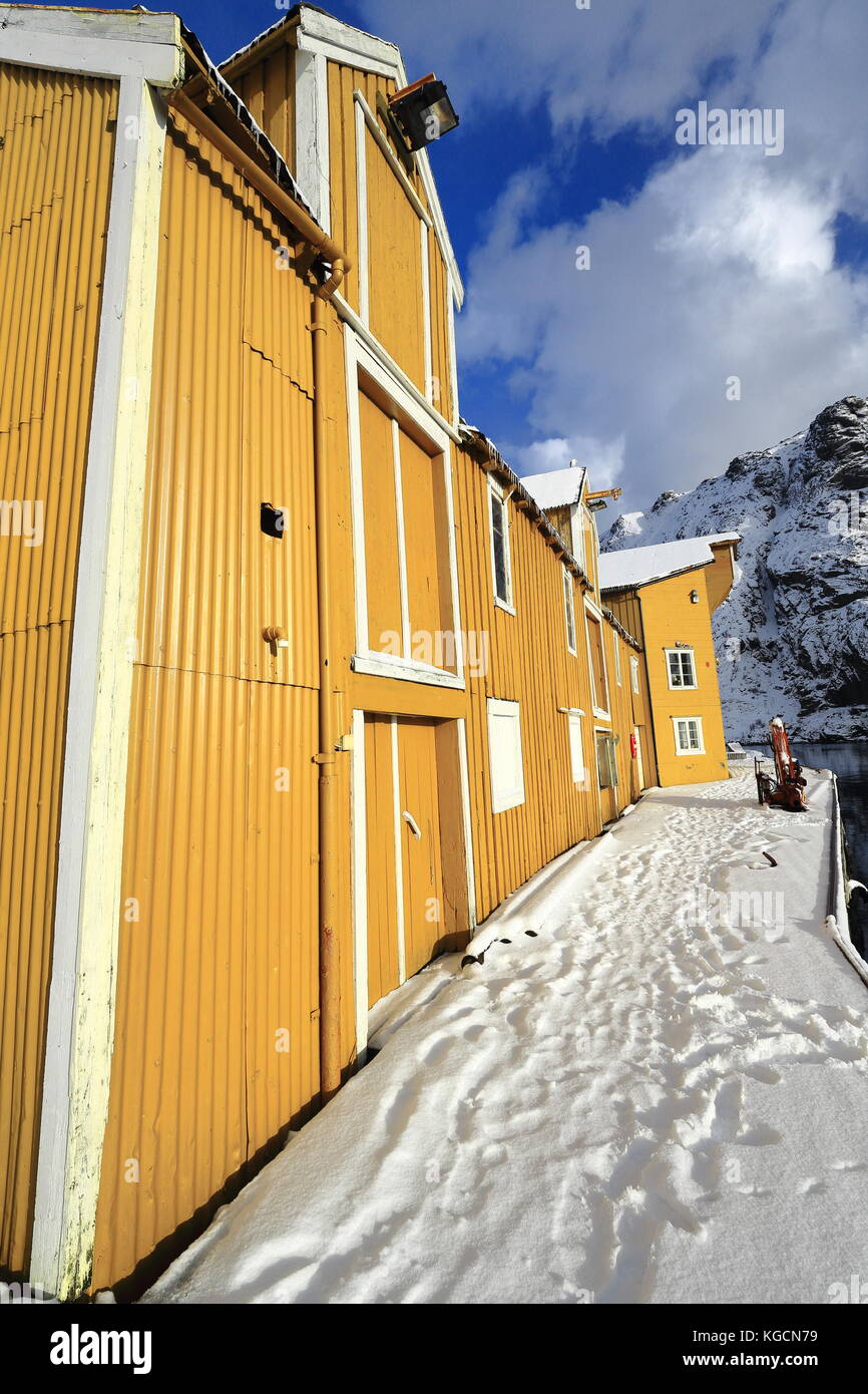 Wooden port warehouse painted yellow-closed doors and windows-white ...