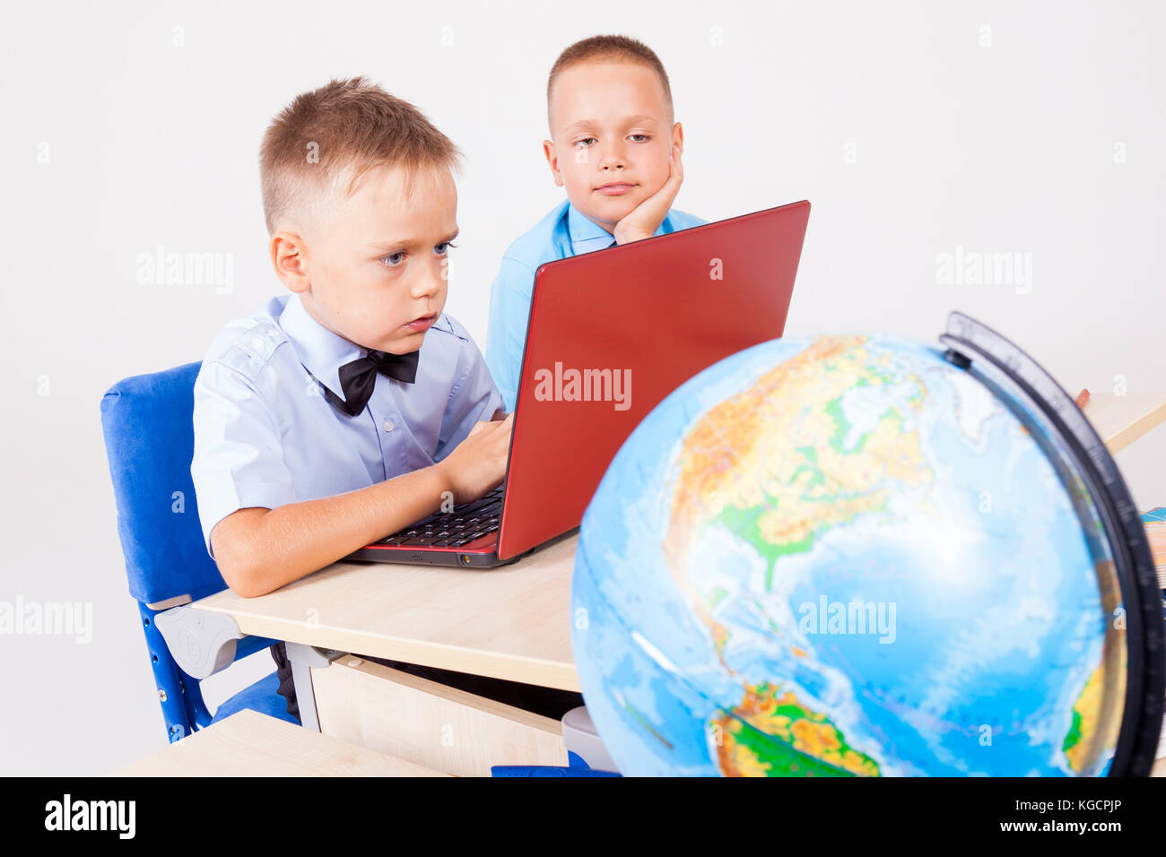 two boys sit at the computer training school Stock Photo - Alamy
