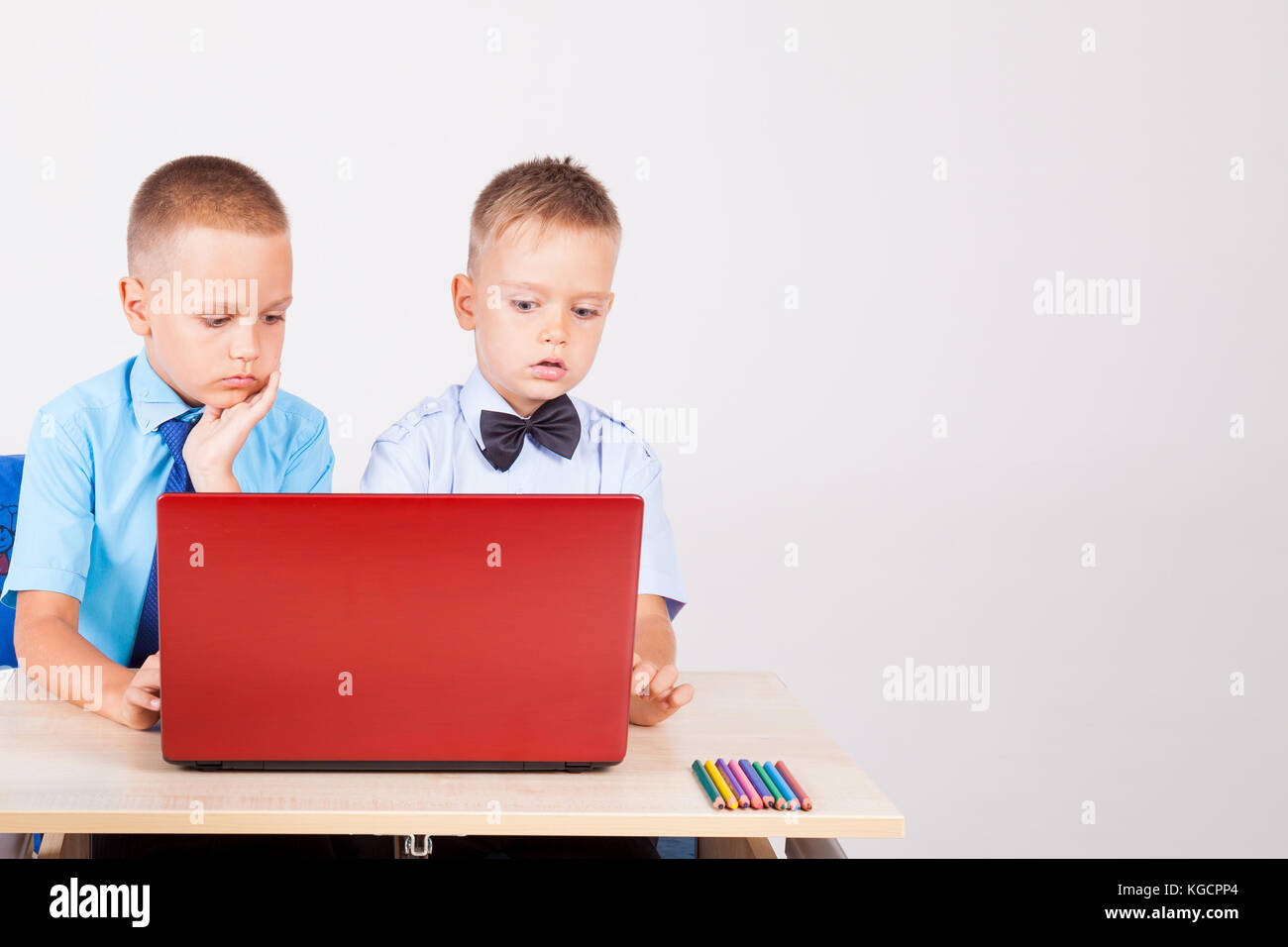 study on the computer two boys at school Stock Photo - Alamy