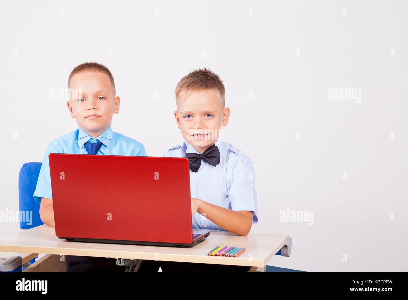 study on the computer two boys at school Stock Photo - Alamy