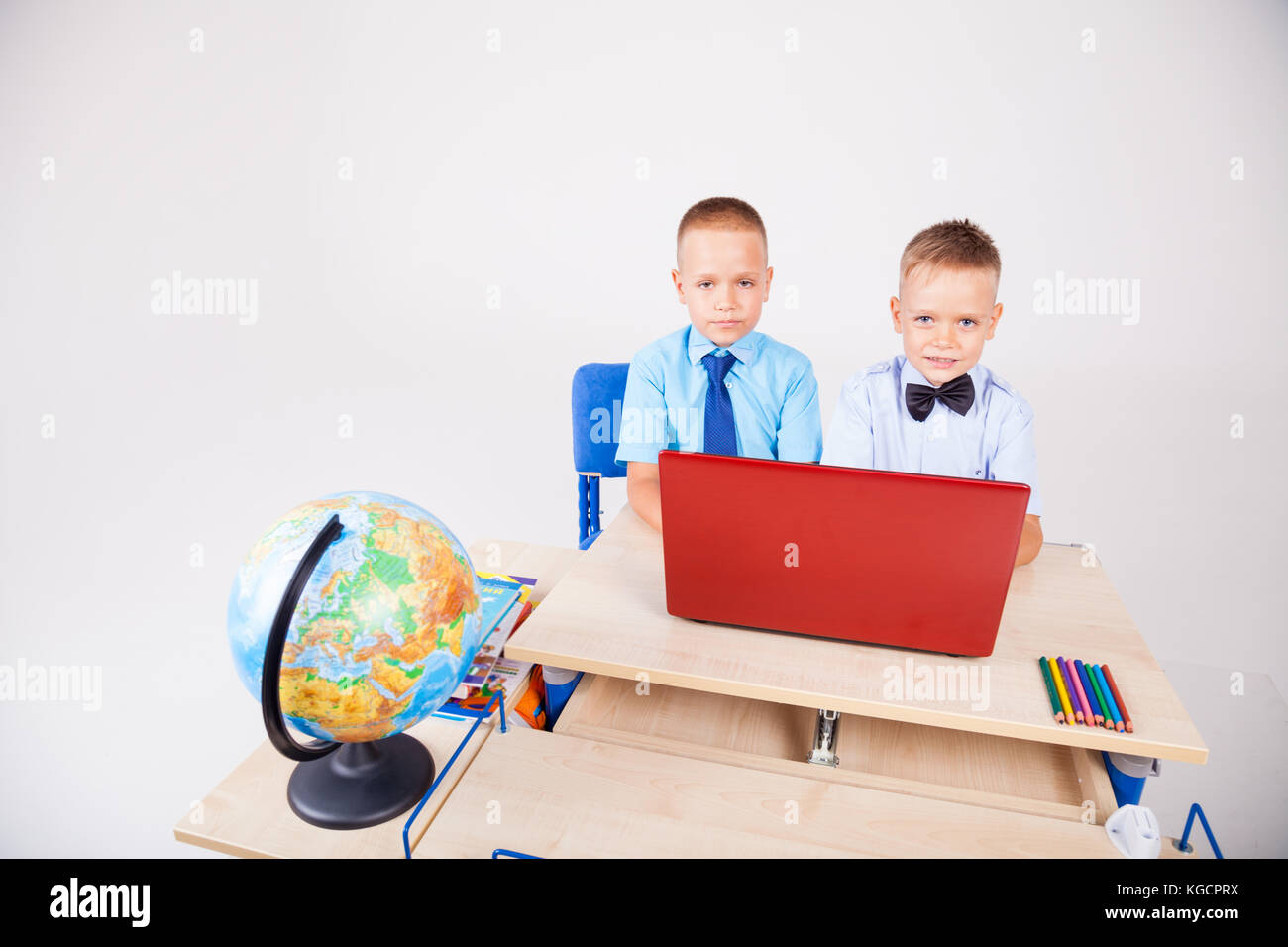 study on the computer two boys at school Stock Photo - Alamy