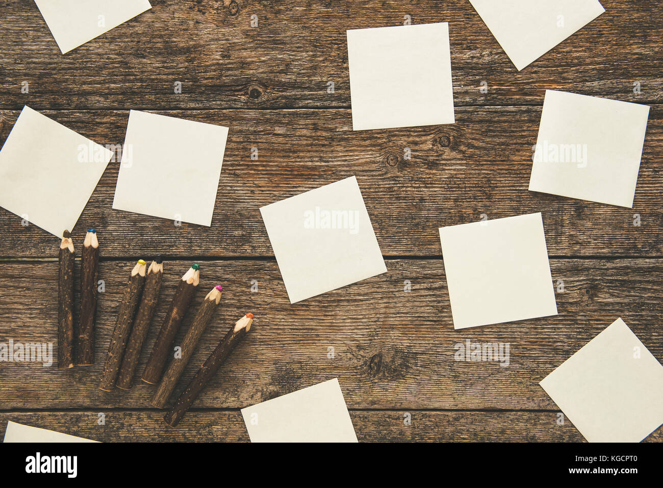 Sticky notes and colored pencils on vintage wooden background Stock ...