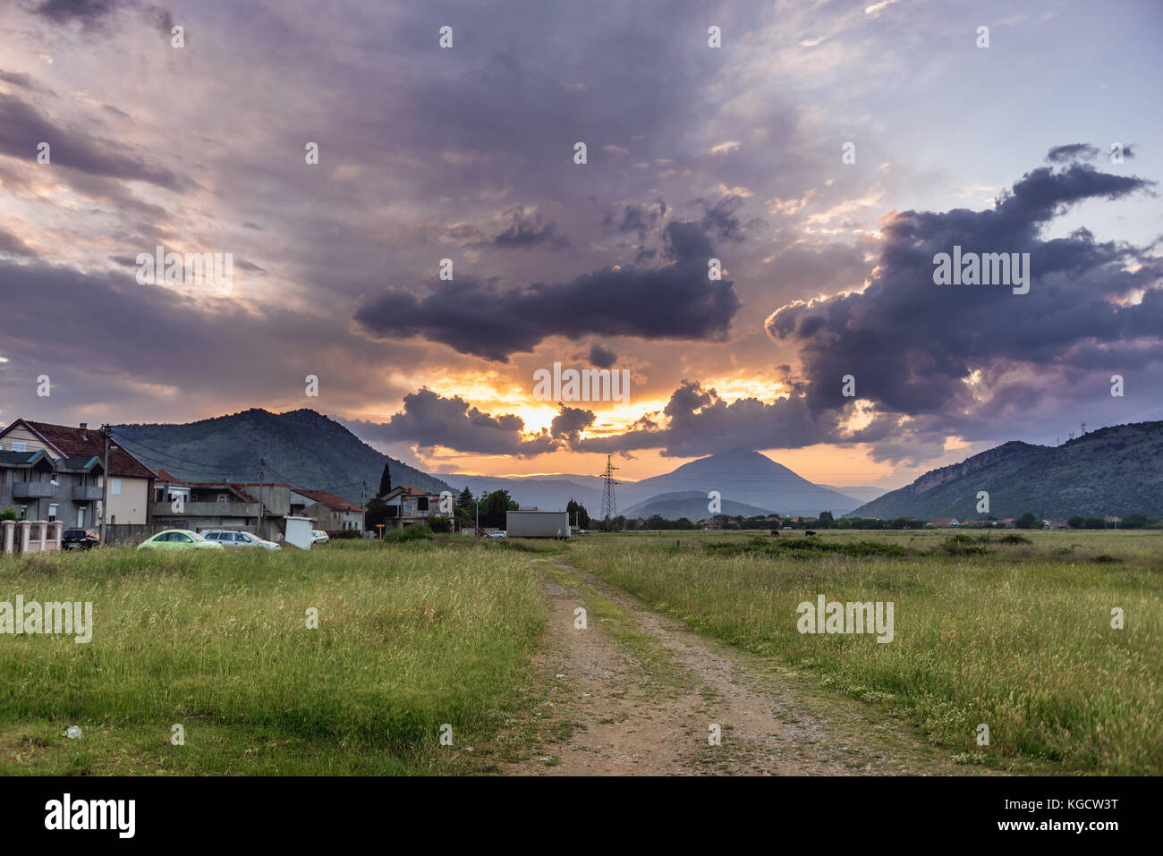 Sunset above mountains seen from outskirts of Podgorica, capital city ...