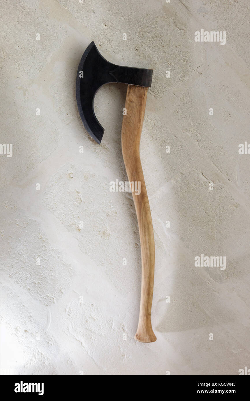 Ancient battle axe on the stone background white wall. With clipping ...