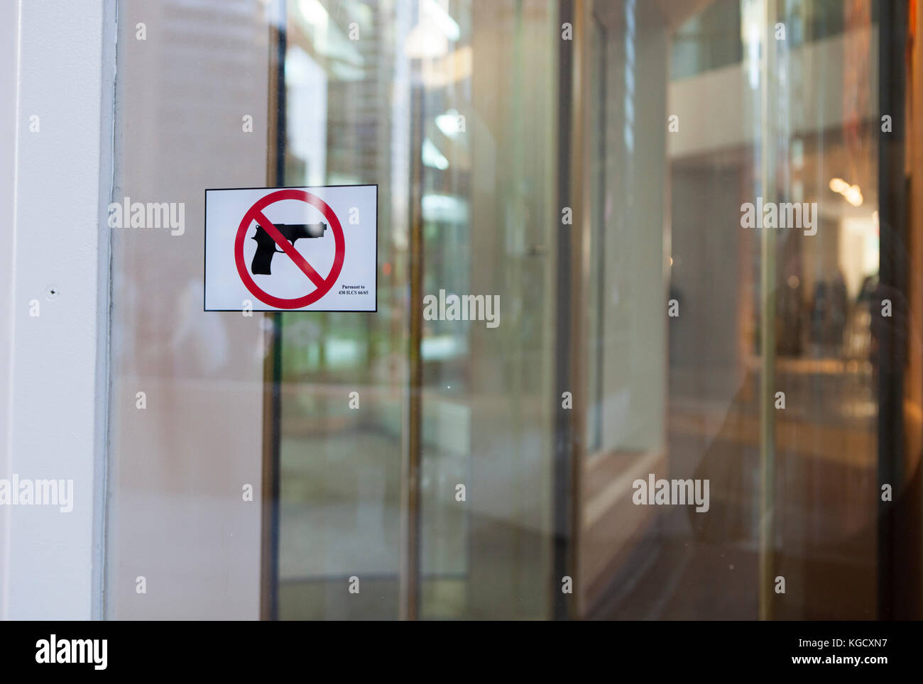 A sign forbidding guns is seen on an office building in downtown ...