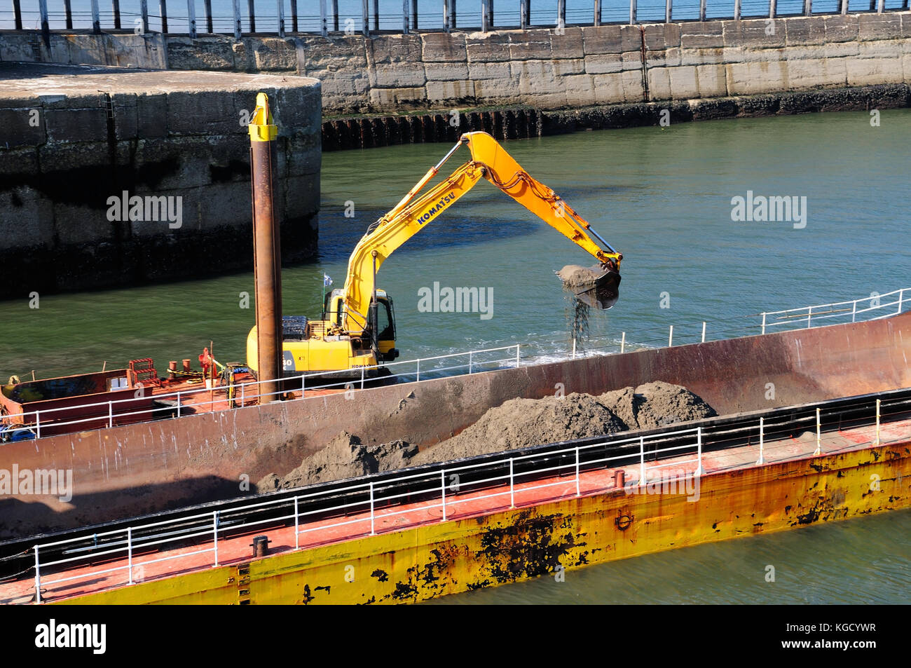Dredging the shipping channel at the entrance to Whitby harbour Stock ...