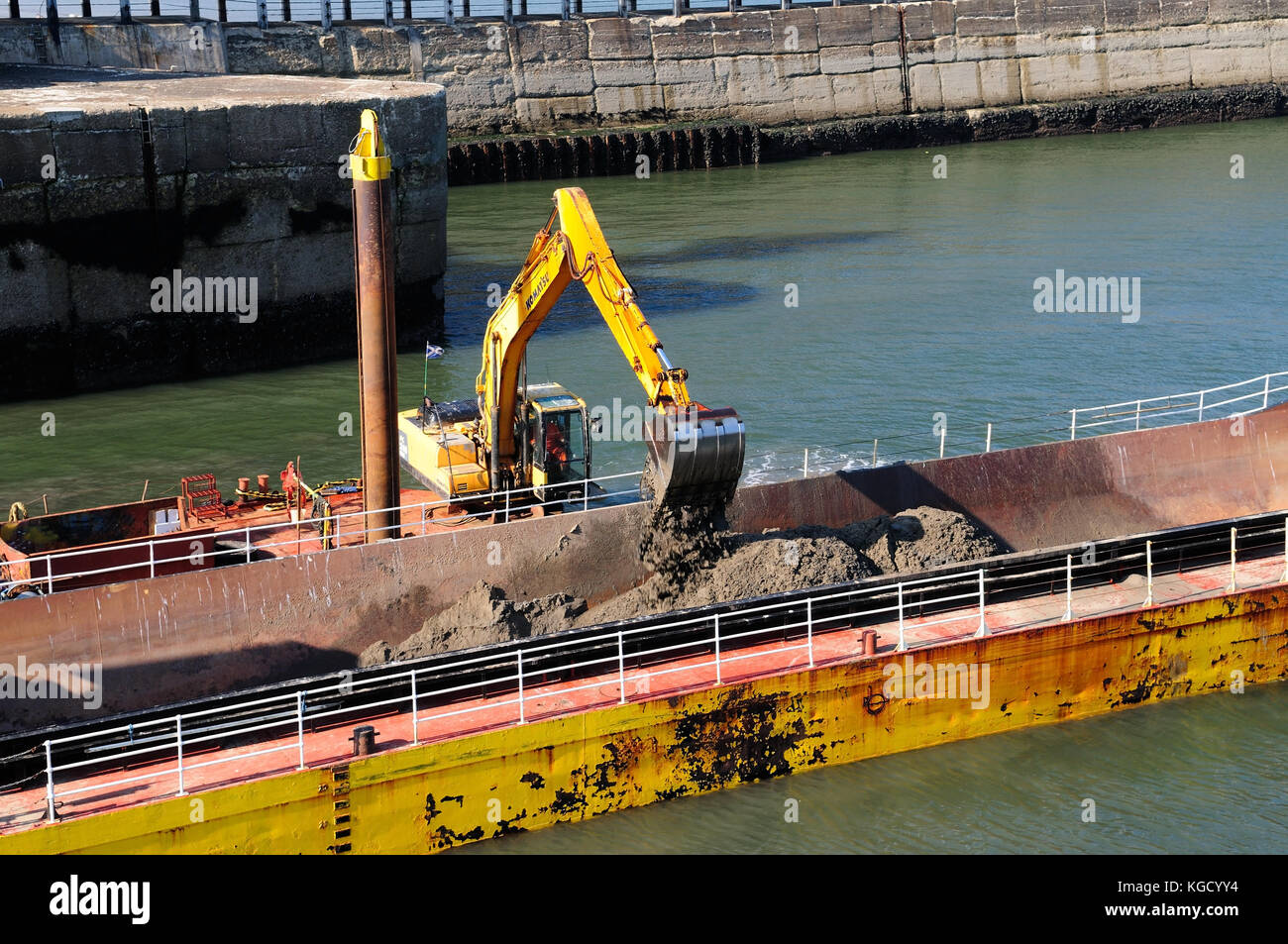 Dredging the shipping channel at the entrance to Whitby harbour Stock ...