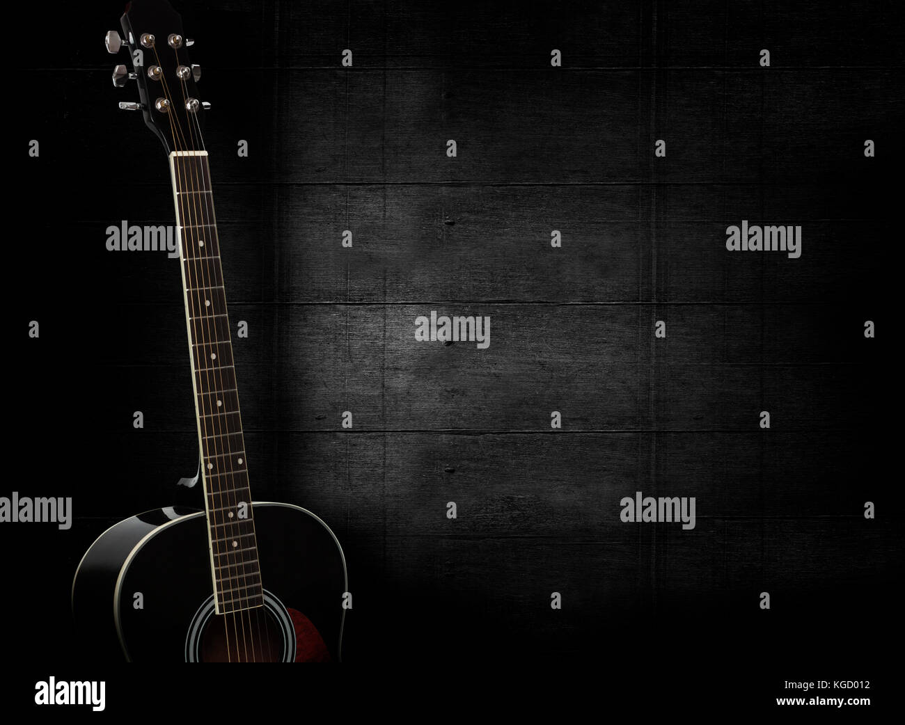 Black acoustic guitar on dark black wooden background Stock Photo - Alamy