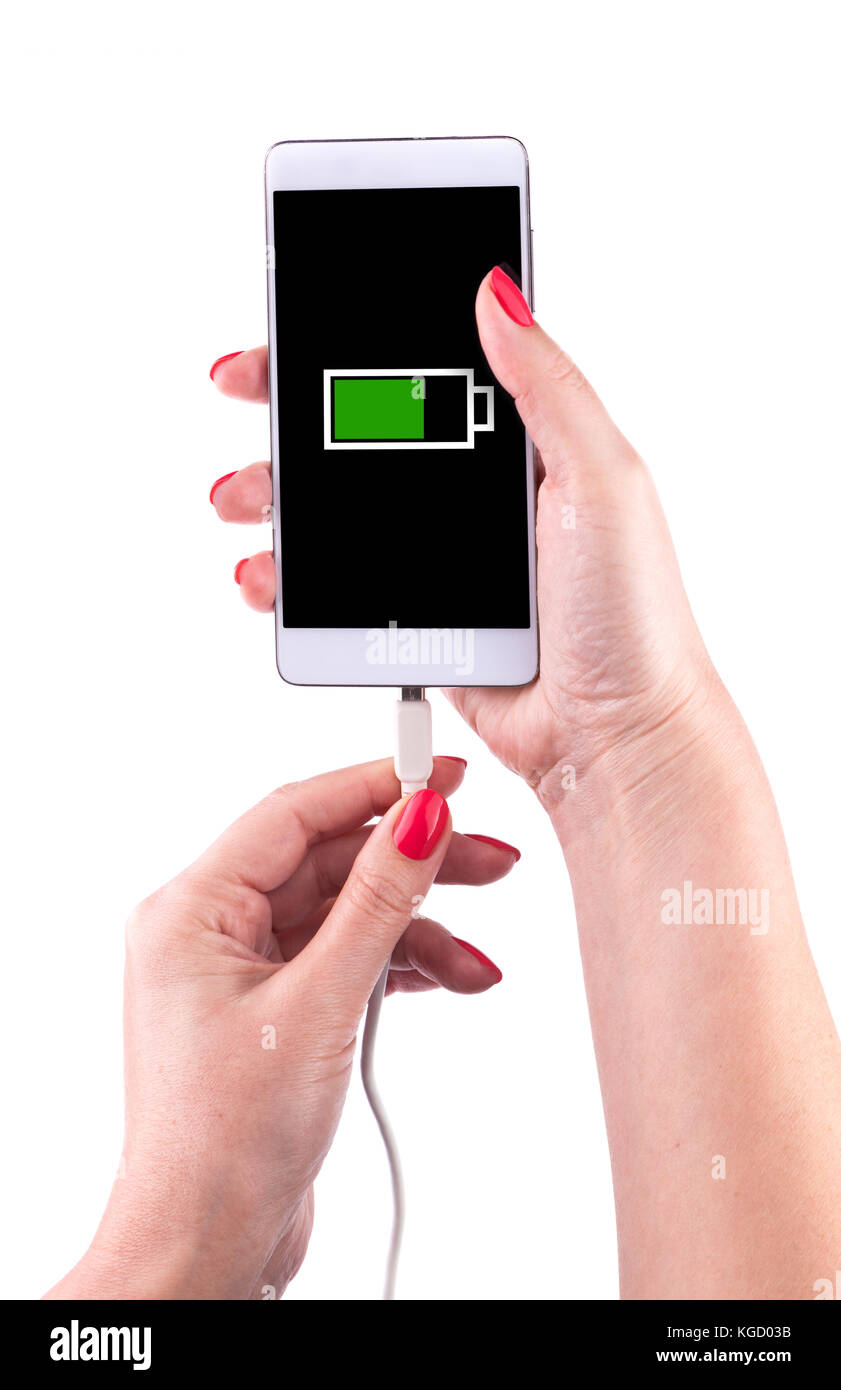 Female hand holding a smartphone and connecting charger, isolated on ...