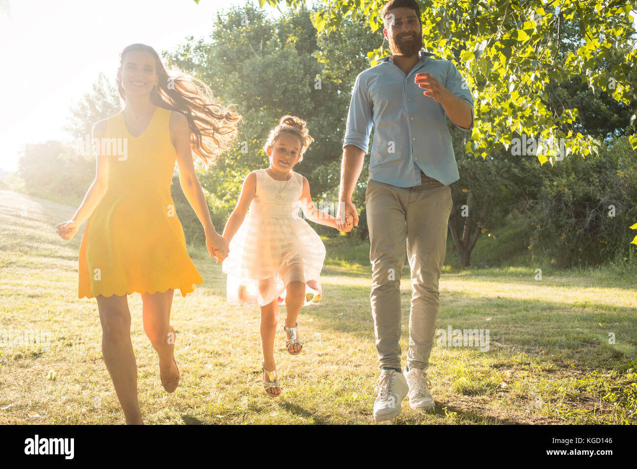 Full length of two happy parents with a healthy lifestyle wearing ...