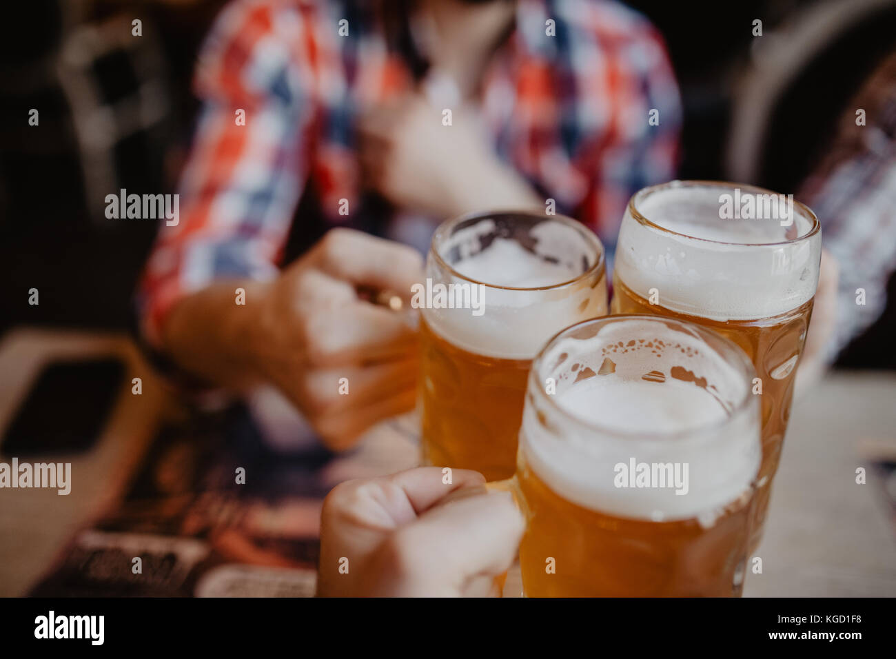 happy male friends drinking beer and clinking glasses at bar or pub ...