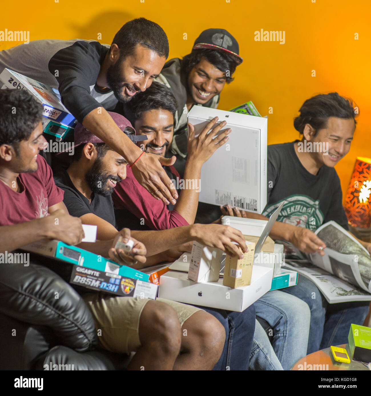 A group of friends opening packages and having fun Stock Photo - Alamy