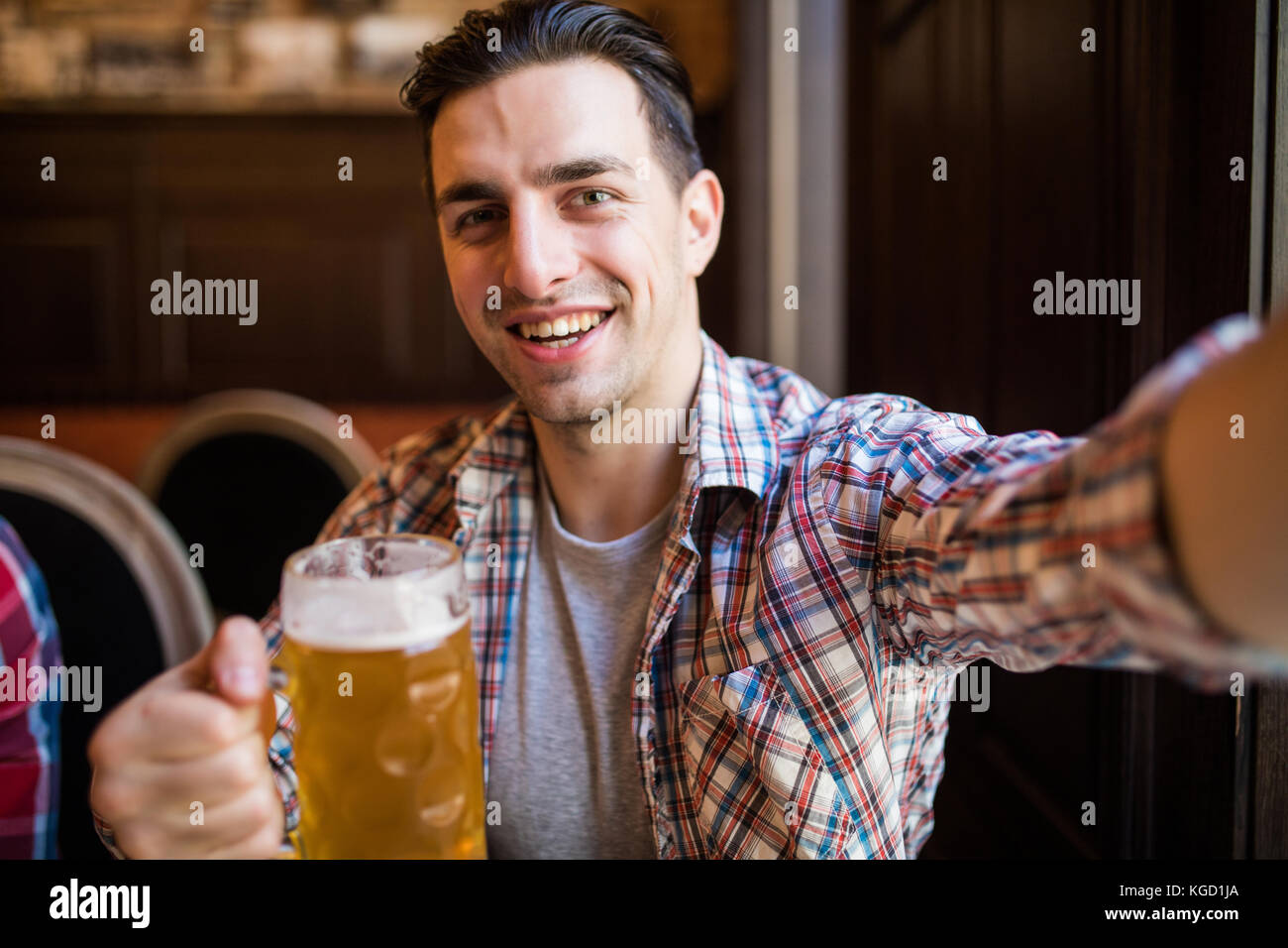 Shot of an excited young man screaming happily taking a selfie with a ...