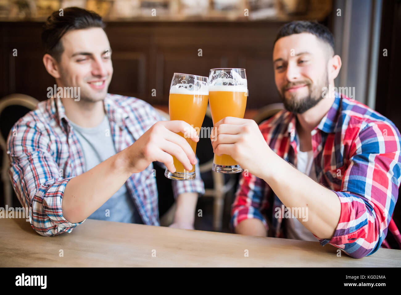 Two handsome men is celebrating meeting and smiling Stock Photo - Alamy
