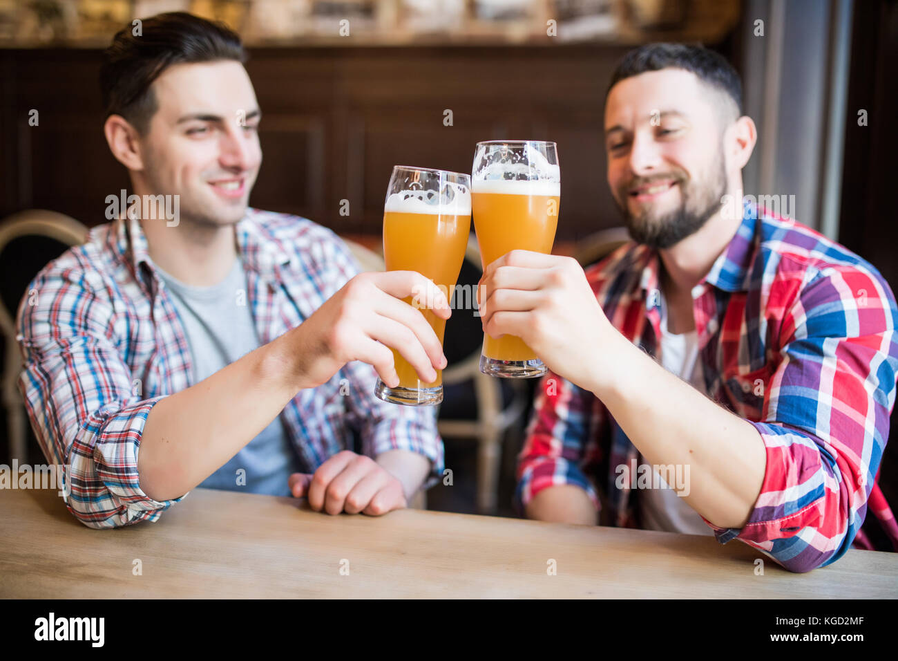 Two handsome men is celebrating meeting and smiling Stock Photo - Alamy