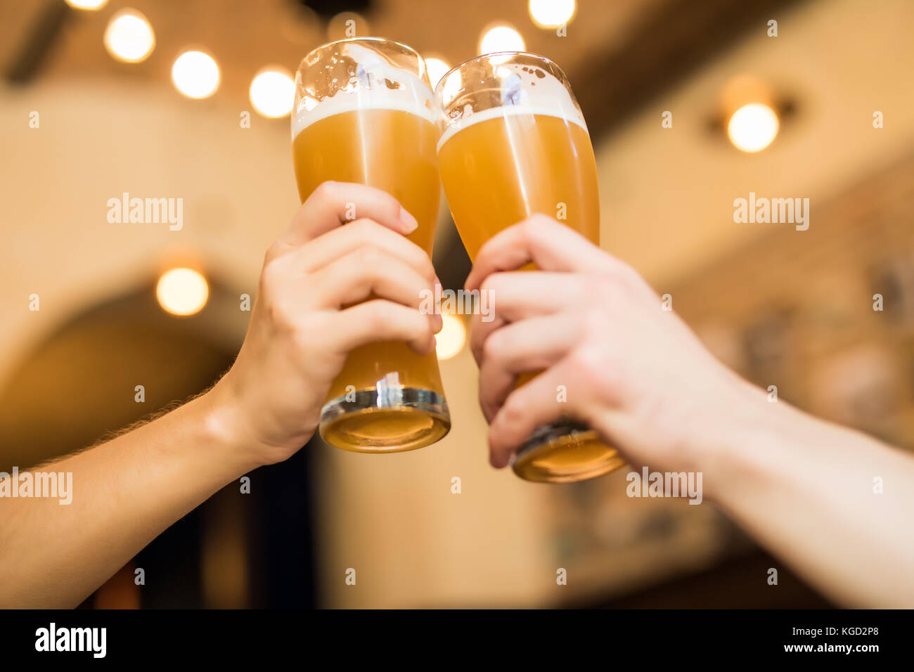 Men cheers with beer in glasses in pub Stock Photo - Alamy