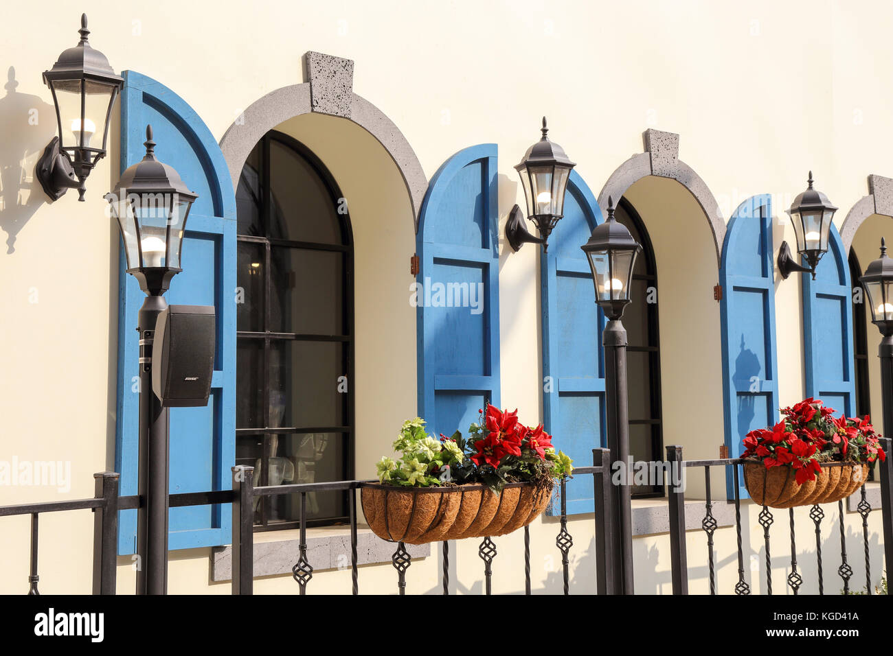 Exterior window decorated with shutters, lamps and flower vases Stock ...