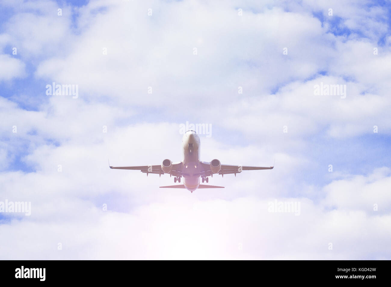 Plane flying through clouds in the sky. Jet aircraft in the air Stock ...