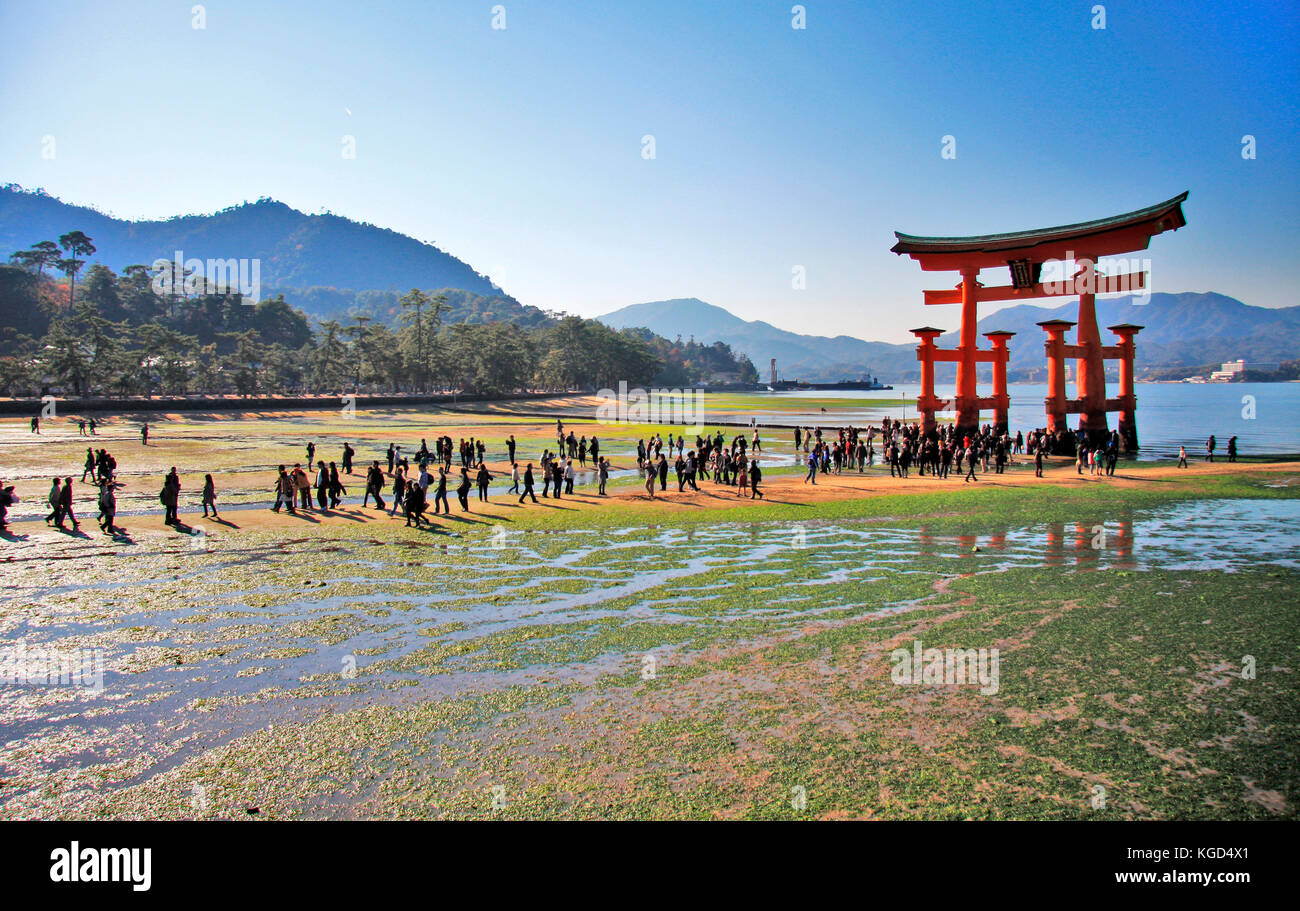 Crowds gatering under a Torii gate whilst the tide is out Stock Photo ...