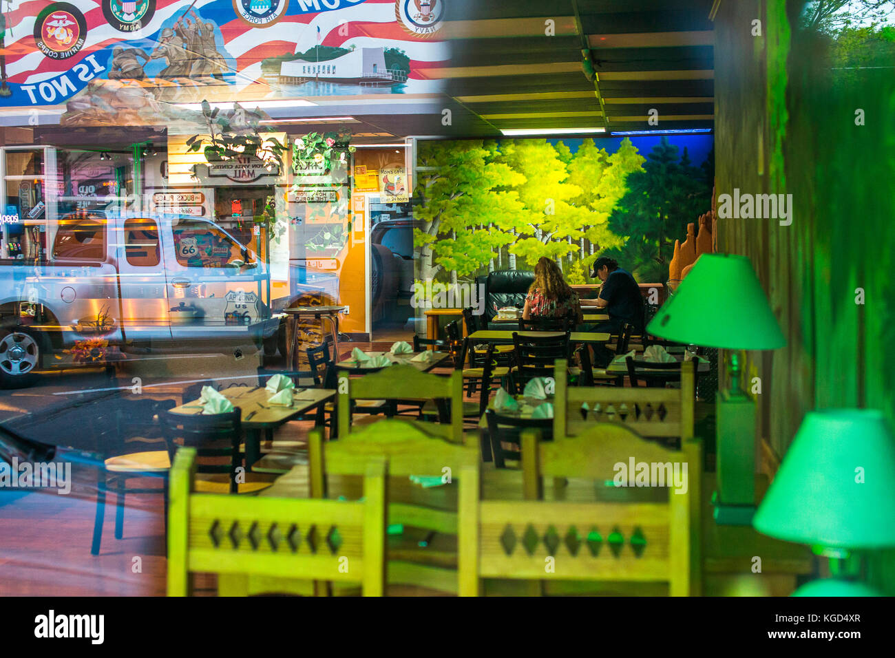A couple eating whilst seeing the street in the window reflection Stock ...