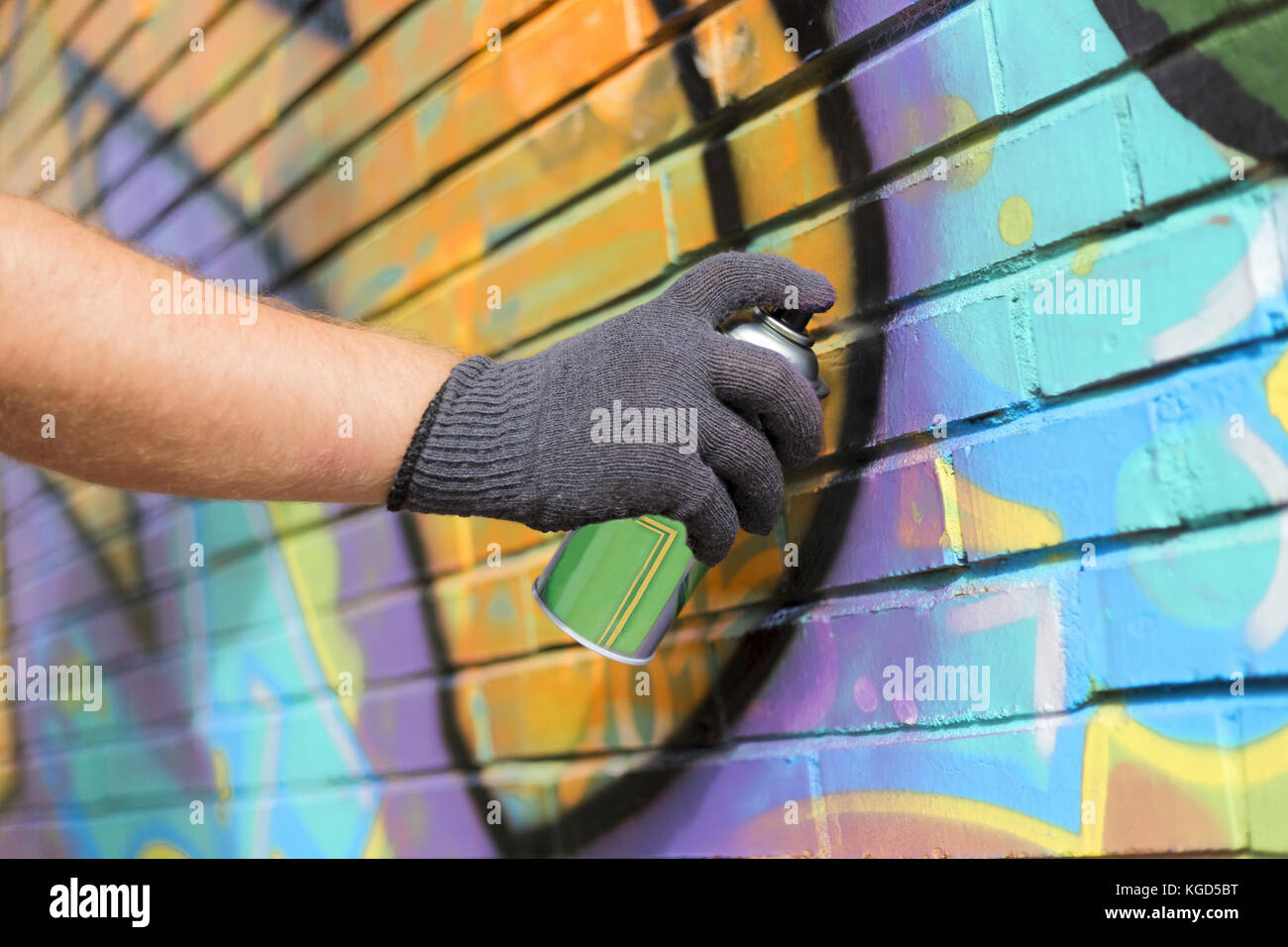 A hand with a grey glove using graffiti paint Stock Photo - Alamy