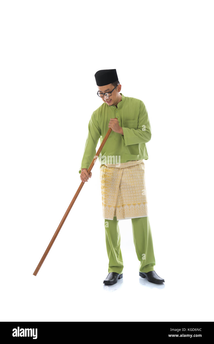 malay male holding a stick Stock Photo - Alamy