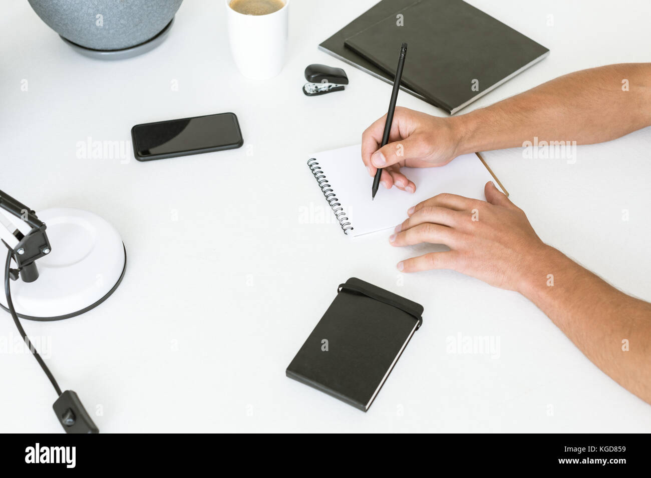 man writing in notepad Stock Photo - Alamy