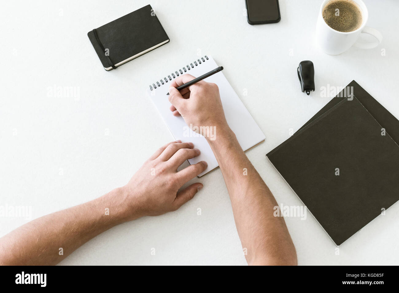 Male hands writing in notepad Stock Photo - Alamy