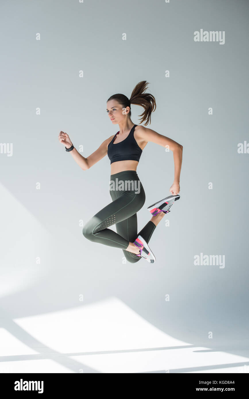 jumping girl in sportswear Stock Photo - Alamy