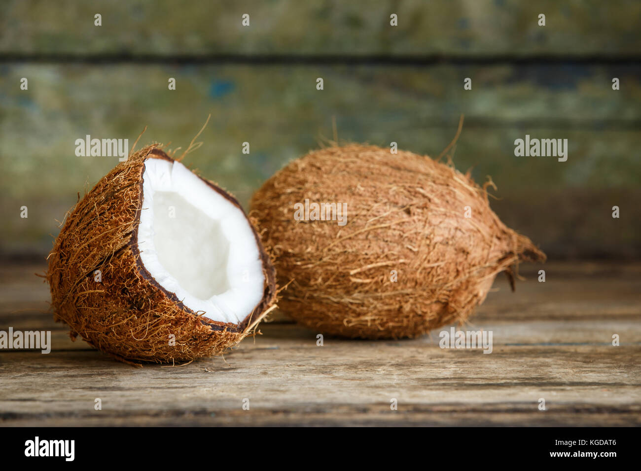 Fresh whole and cut in half coconuts on wooden background Stock Photo ...