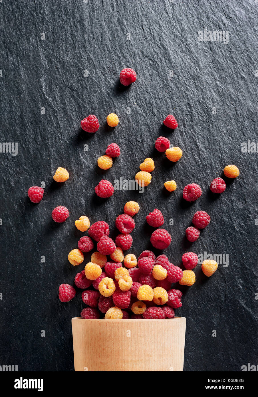 Raspberry explosion. Photo of raspberry in bowl on black slate. Top ...