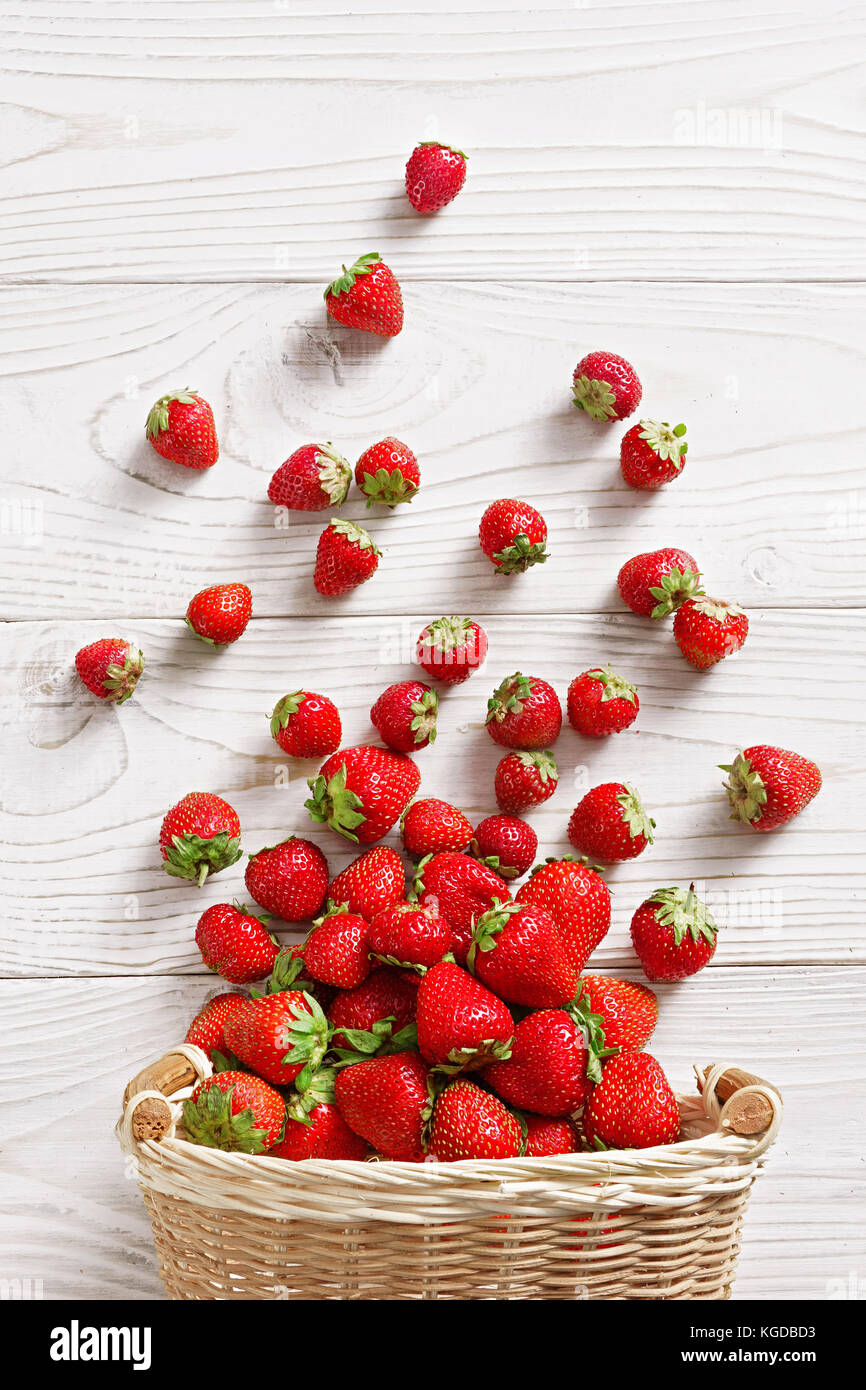 Strawberry explosion. Photo of strawberry in basket on white wooden ...