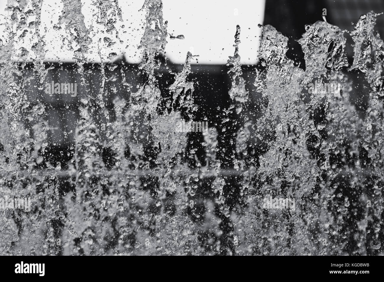 Close-up of a splash of water in a fountain. Black and white ...