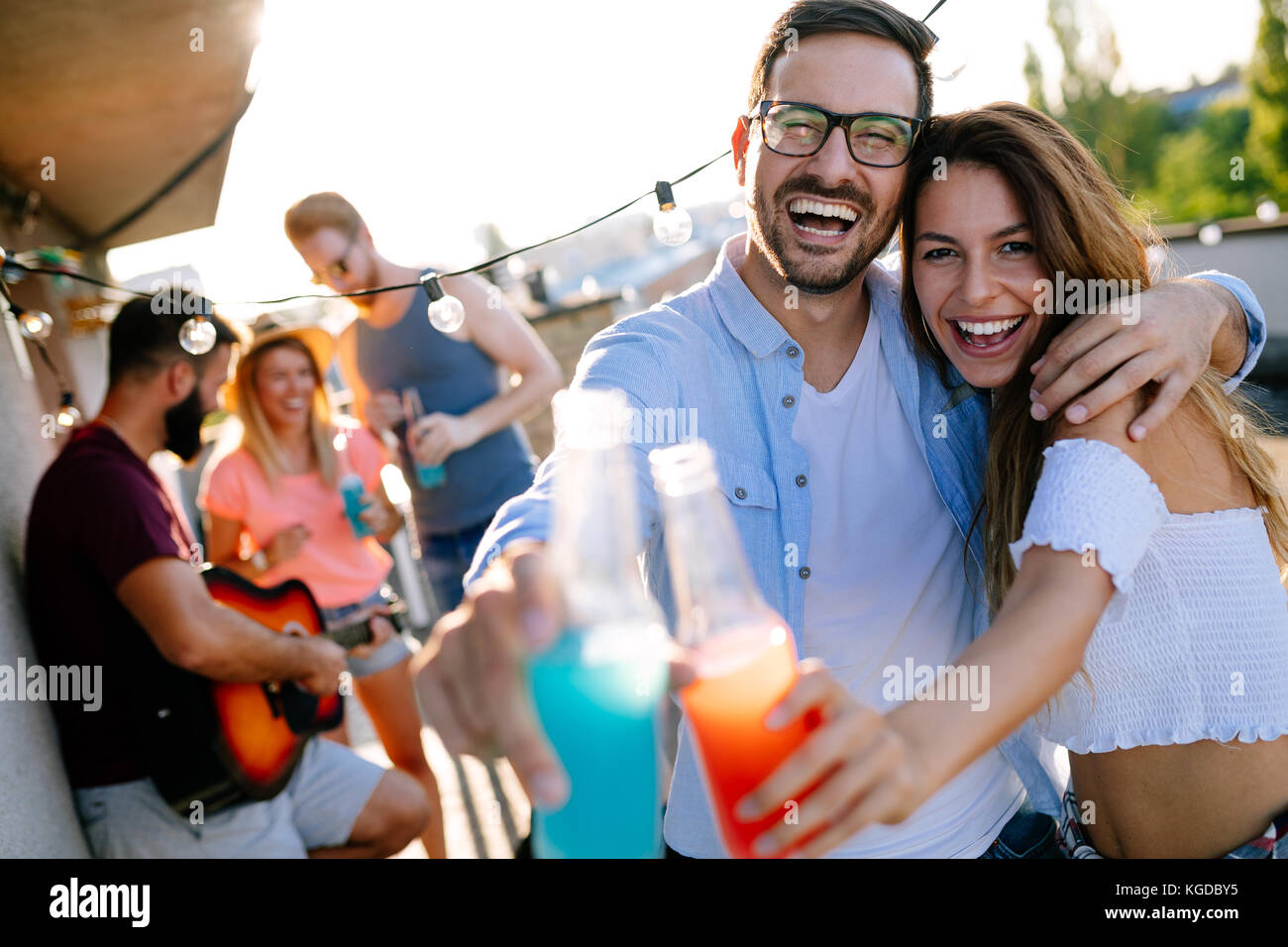 Happy couple having fun time at party Stock Photo - Alamy
