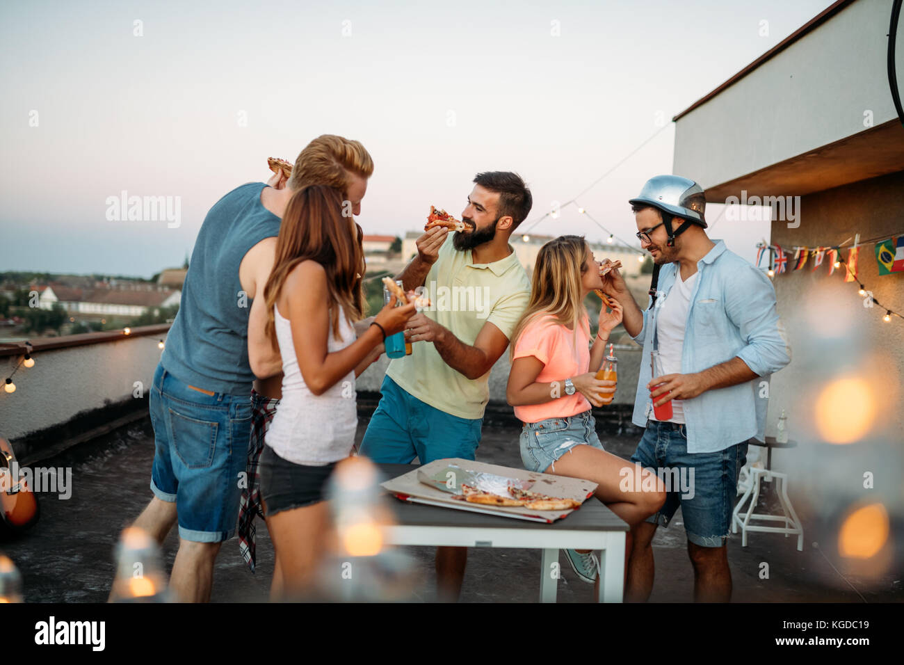 Group of happy friends having party on rooftop Stock Photo - Alamy