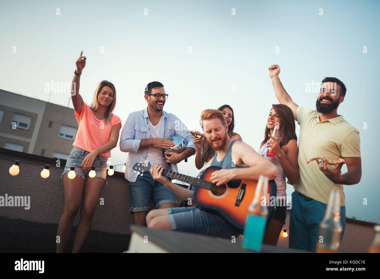Group of happy friends having party on rooftop Stock Photo - Alamy