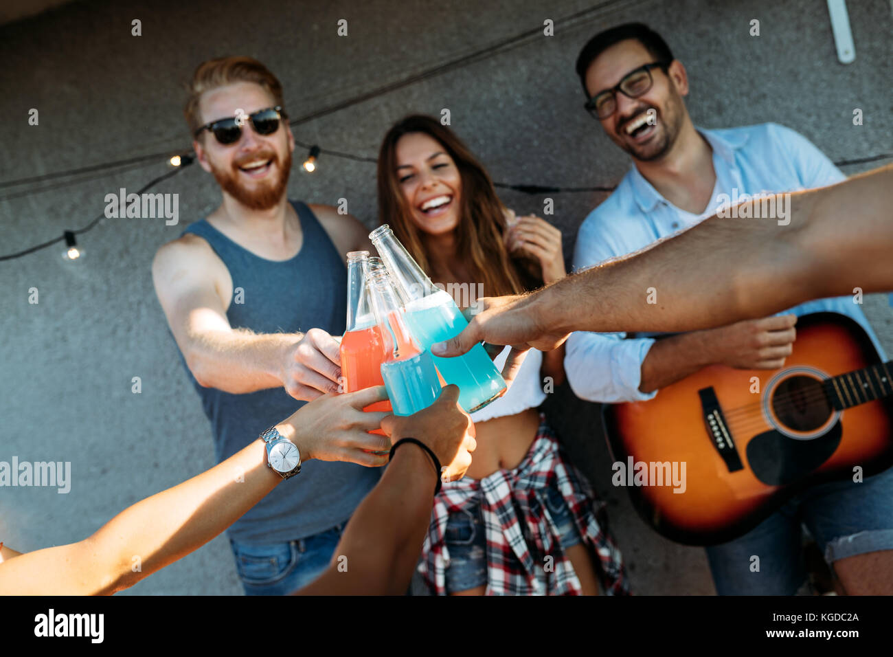 Group of happy friends having party on rooftop Stock Photo - Alamy