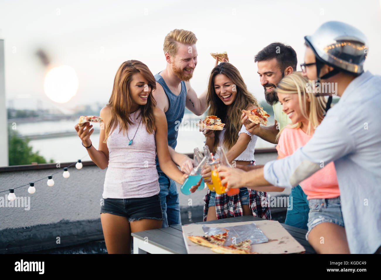 Group of happy friends having party on rooftop Stock Photo - Alamy